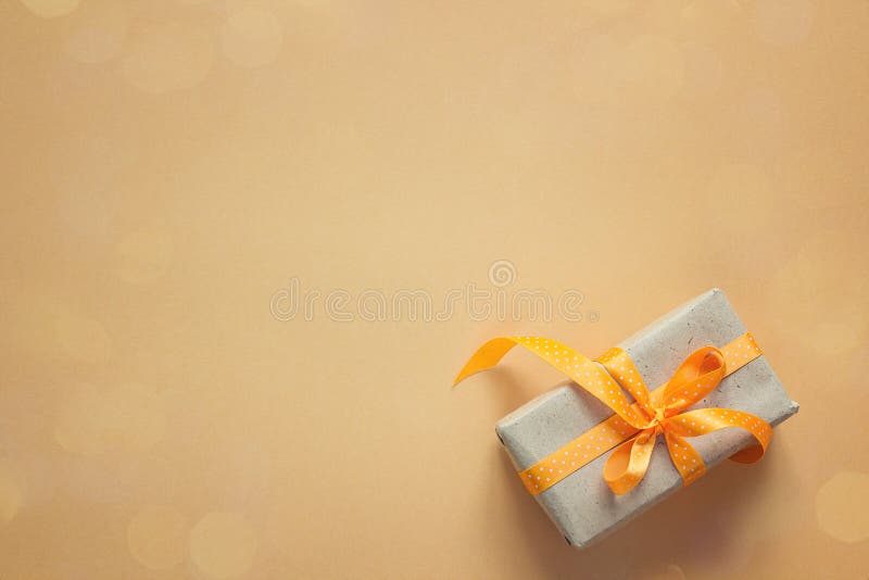 Gift Box with Ribbon on Orange Background and Copy Space for Tex Stock ...
