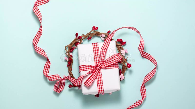 Gift Box Spin Around with a Red Ribbon Bow on Blue Background. Flat Lay ...