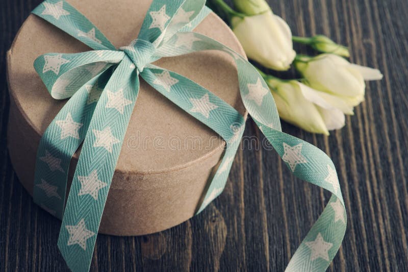 Gift Box with Star Ribbon on Dark Rustic Table Stock Image - Image of ...