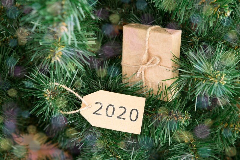 Gift Box and Tag with Text & X22;2020& X22; on Christmas Tree Stock ...