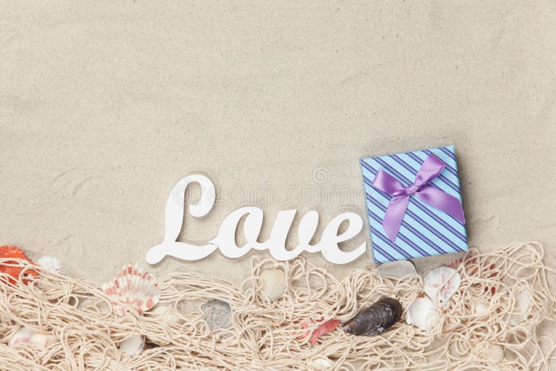 Gift Box and Word Love with Net and Shells Stock Photo - Image of sand ...