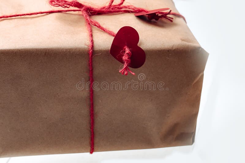 Gift Box Wrapped in Kraft, Tied with a Rope with Hearts. Eco-friendly ...