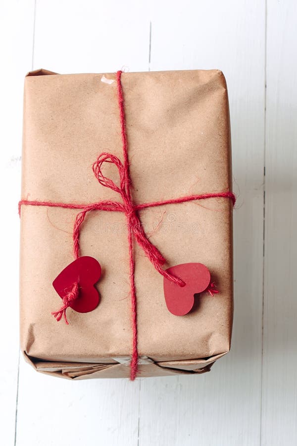 Gift Box Wrapped in Kraft, Tied with a Rope with Hearts. Eco-friendly ...