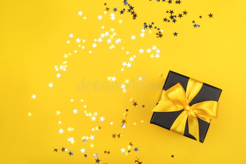 Gift Box on Yellow Background with Sparkling Confetti Stock Image ...