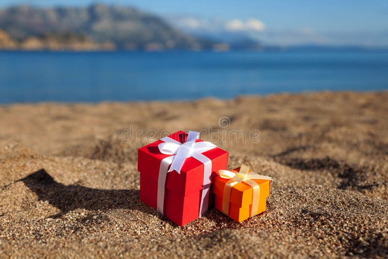 Gift boxes in a beach stock photo. Image of location - 79642004