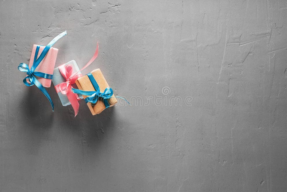 Gift Boxes in Craft Paper on a Concrete Background Stock Photo - Image ...