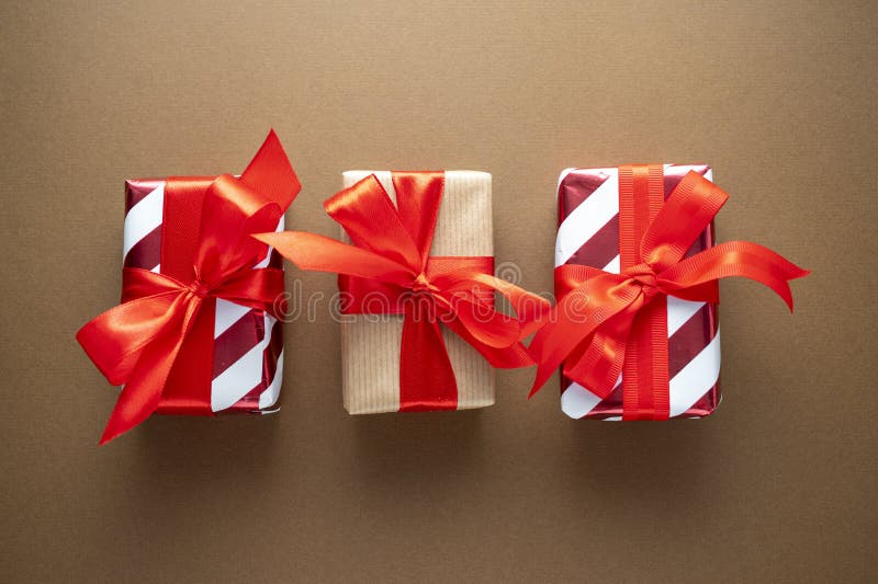 Gift Boxes with Red Bows on Brown Background, Flatlay. Christmas ...