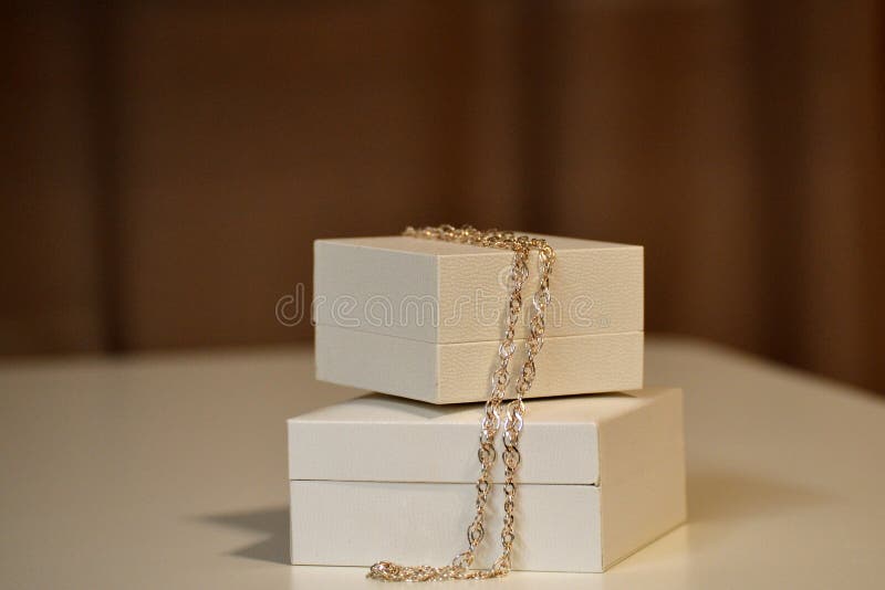 Gift Boxes on a Table with a Gold Chain Stock Photo - Image of ...
