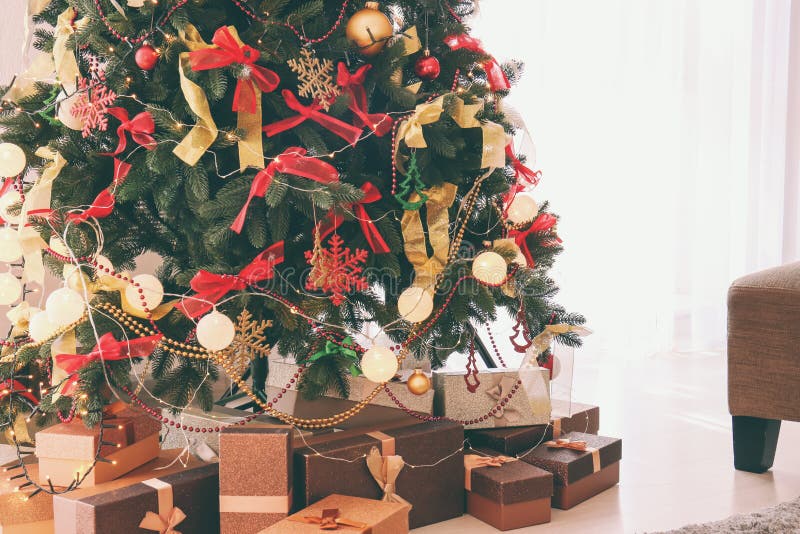 Gift Boxes Under Beautiful Christmas Fir Tree Indoors Stock Photo ...