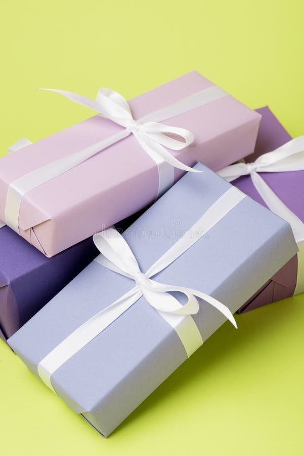 Gift Boxes with White Ribbons on Yellow Surface Stock Image - Image of ...