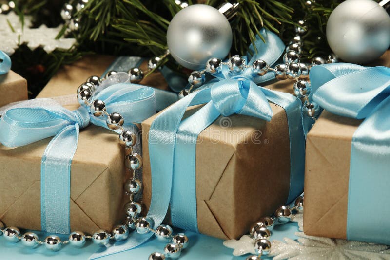 Gift Boxes Wrapped in Craft Paper with Blue Satin Ribbons Stock Photo ...