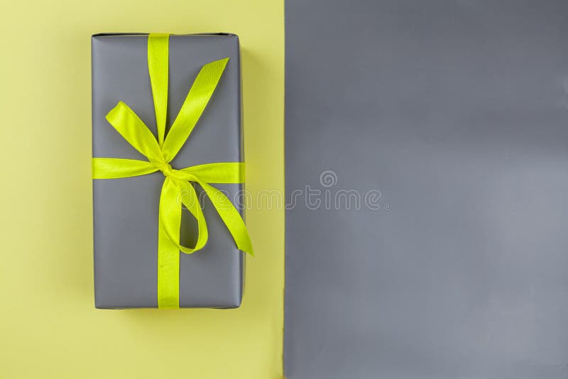 The Gift is Packaged in Perfect Gray on a Yellow Background and a Gray ...