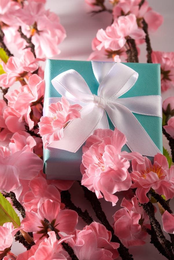Gift with Pink Flower and Green Leaves Stock Photo - Image of knot ...
