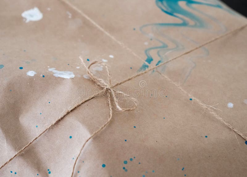 The Gift is Tied with a Thin Brown Rope. Unusual Packaging Stock Photo ...