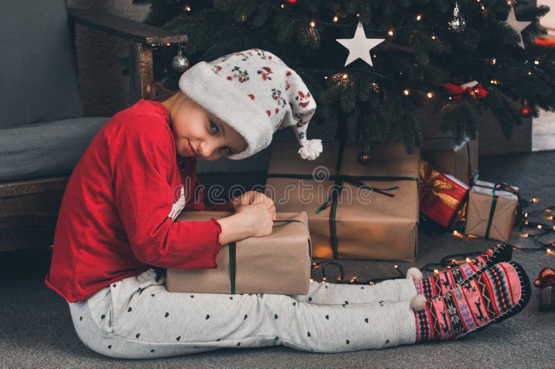 Gift. a Gift Under the Christmas Tree in a Red Package. Christmas New ...