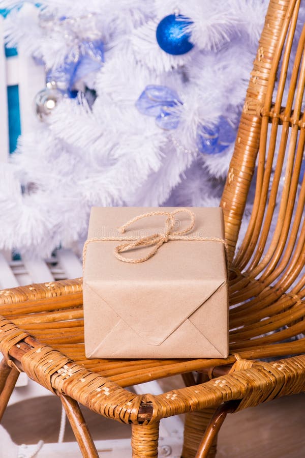 Gift on a wicker chair stock photo. Image of retro, christmas - 81533382