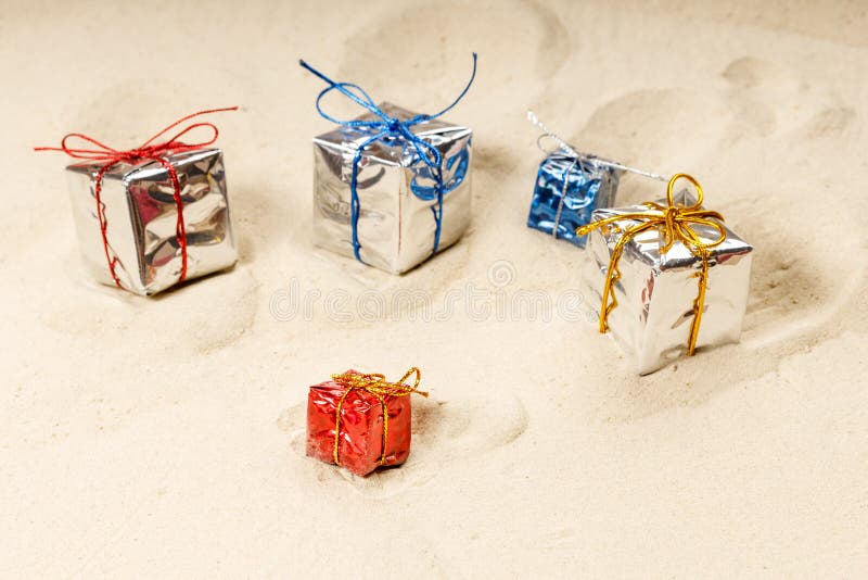 Gift Wrappings are Scattered on the Sand Stock Photo - Image of gift ...