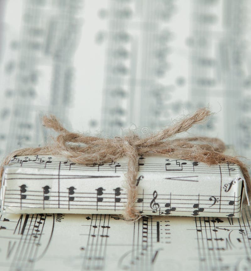 Giftbox on Music Sheet. a Musical Gift on Notes Background Stock Photo ...