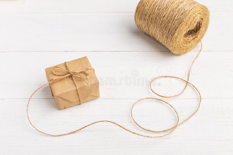 Gifts from Kraft Paper on a White Table with Threads. Stock Image ...