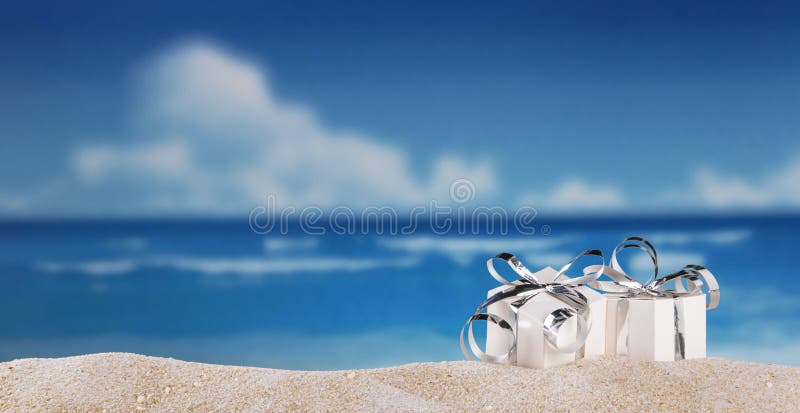 Gifts with Silver Ribbon in the Sand on Beach on a Sunny Day Stock ...