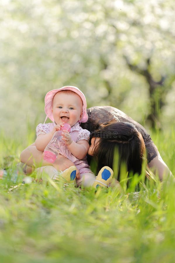Giggling Child with Mother stock image. Image of green - 37449399