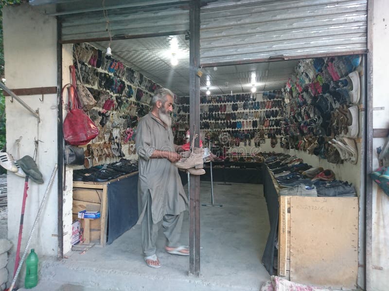 Gilgit, Pakistan, 14-11-2023, an Old Man Looking for Shoes in Shop ...