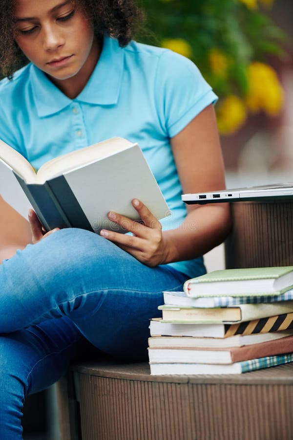 Girl Reading Textbooks stock photo. Image of book, outdoors - 169311528