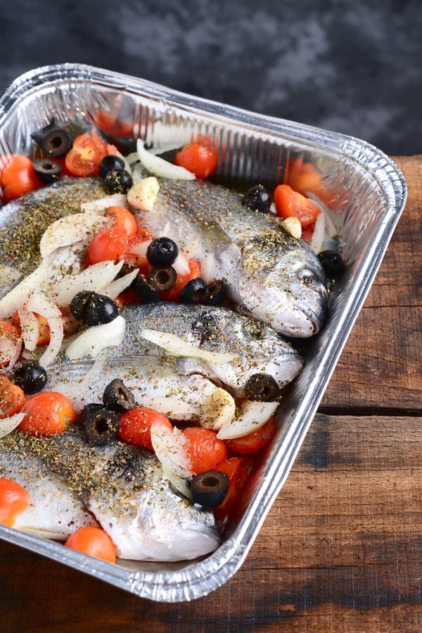 Gilt-head fish preparation stock image. Image of onion - 27315189