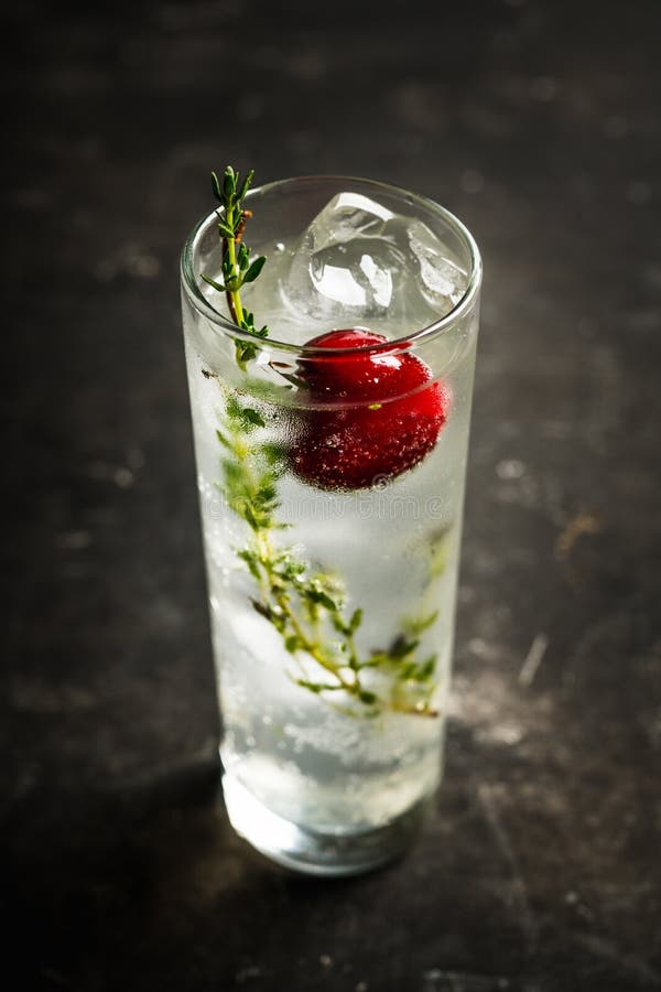 Gin Based Cocktail with Cherries and Thyme Herbs on the Rustic ...
