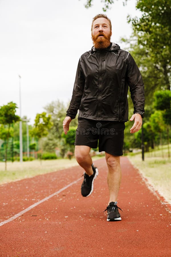 Ginger Bearded Sportsman Doing Exercise while Working Out in Park Stock ...
