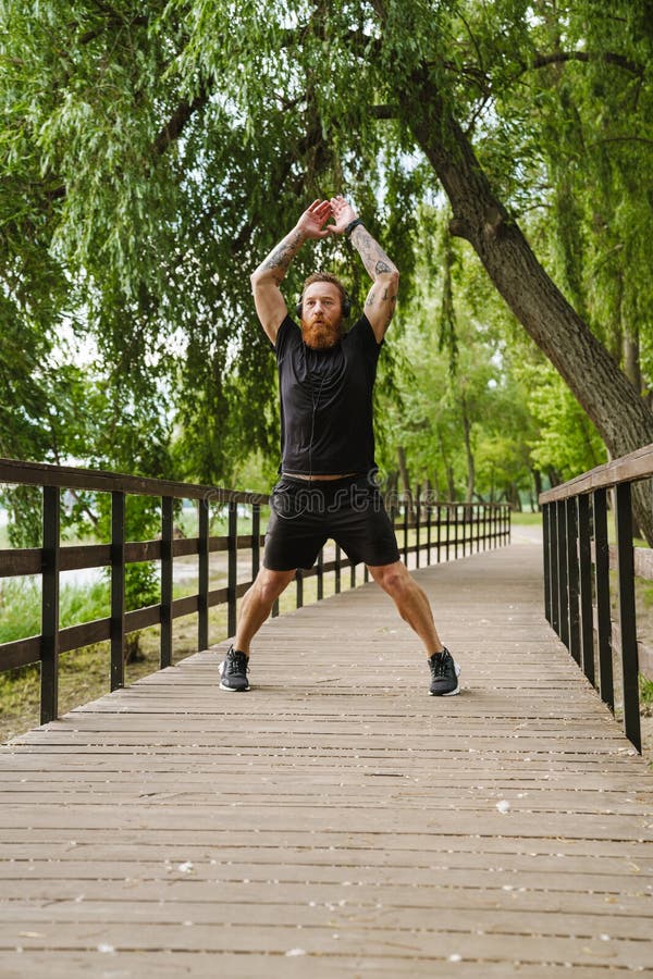 Ginger Bearded Sportsman Doing Exercise while Working Out in Park Stock ...