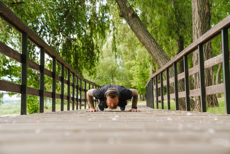 Ginger Bearded Sportsman Doing Exercise while Working Out in Park Stock ...