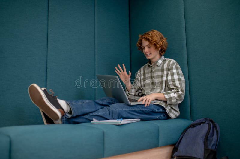Ginger Boy Sitting with a Laptop and Having a Video Call Stock Photo ...