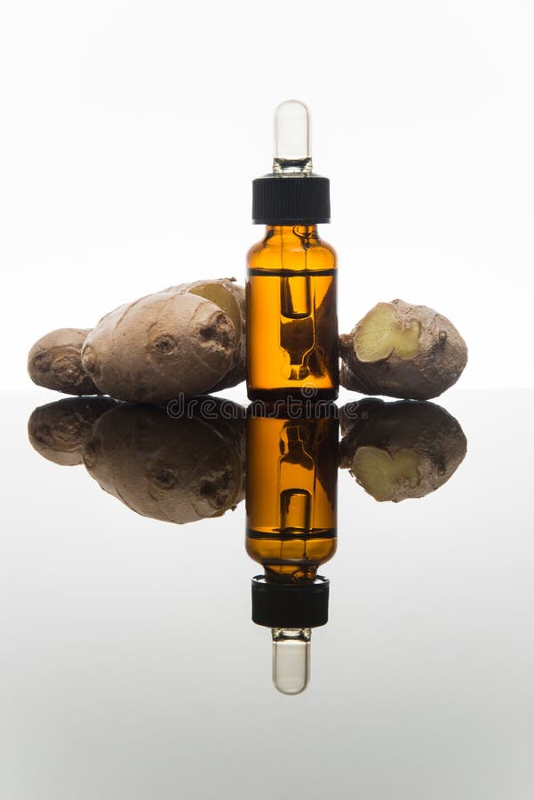 Ginger Essential Oil in Amber Bottle with Ginger Root and Dropper Stock ...