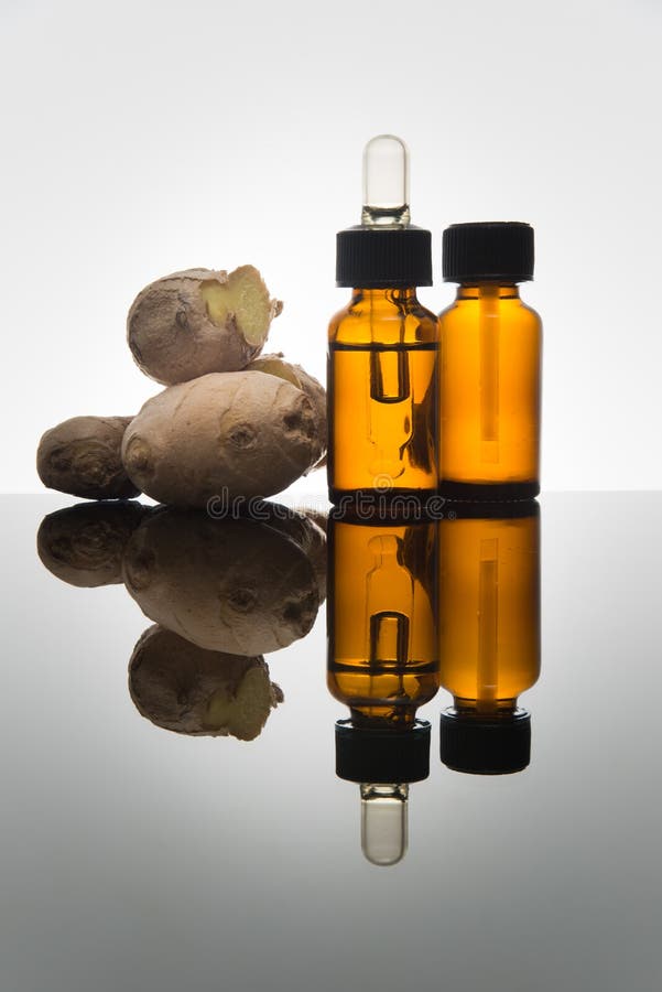 Ginger Essential Oil in Amber Bottle with Ginger Root and Dropper Stock ...