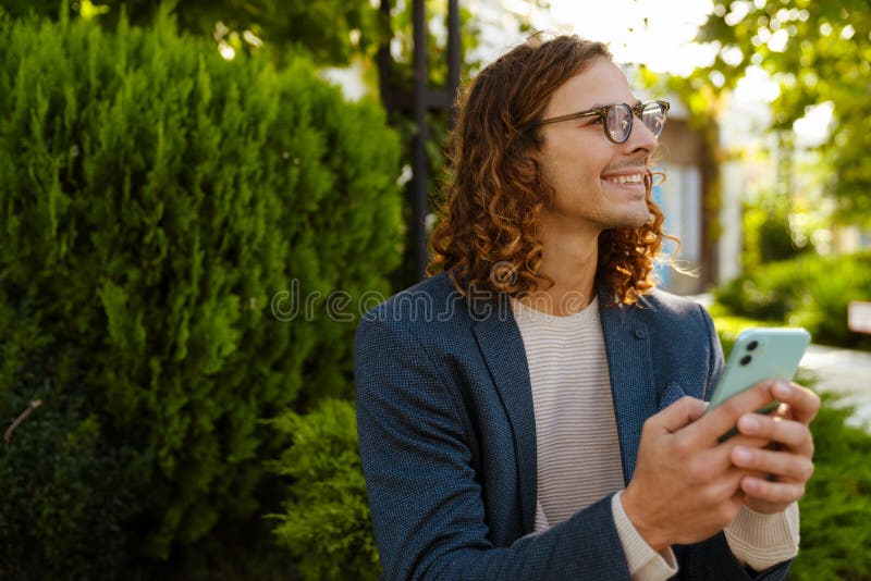 Ginger Man Talking on Mobile Phone while Sitting in Summer Park Stock ...