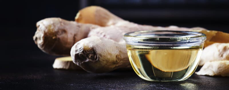 Ginger Oil and Fresh Ginger Root, Dark Table, Selective Focus Stock ...
