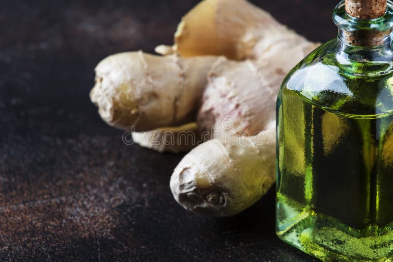 Ginger Oil and Fresh Ginger Root, Dark Table, Selective Focus Stock ...