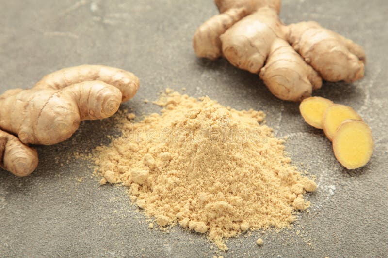 Ginger Powder with Fresh Ginger Root on Grey Concrete Background. Top ...