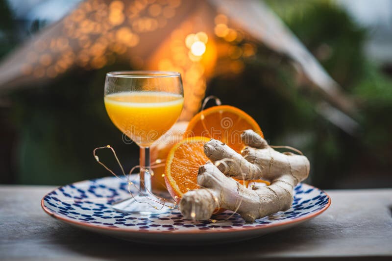 Ginger Shot with Fresh Oranges and Ginger Root on Rustic Table Stock ...