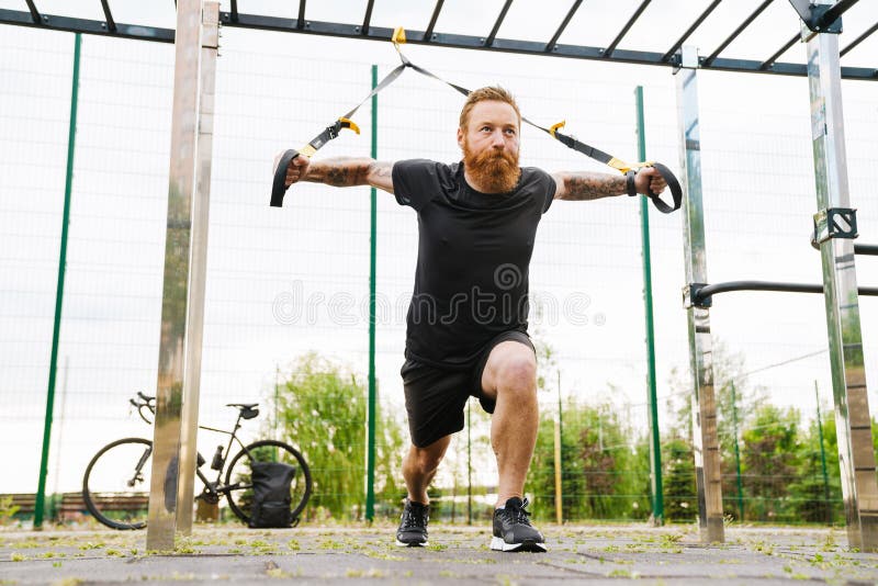 Ginger Sportsman Doing Exercise while Working Out on Playground Stock ...