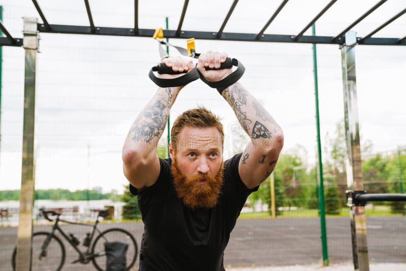 Ginger Sportsman Doing Exercise while Working Out on Playground Stock ...