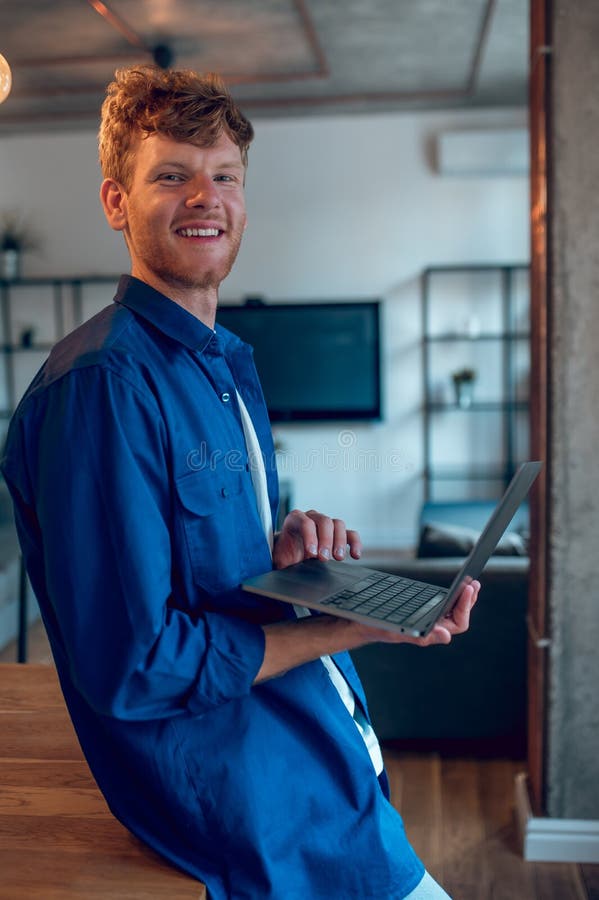A Ginger Young Freelancer Working on a Laptop Stock Image - Image of ...