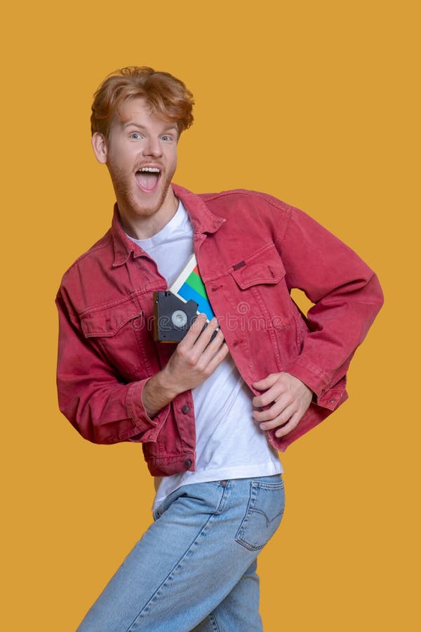 Ginger Young Man in Red Jacket with a Record Stock Photo - Image of ...