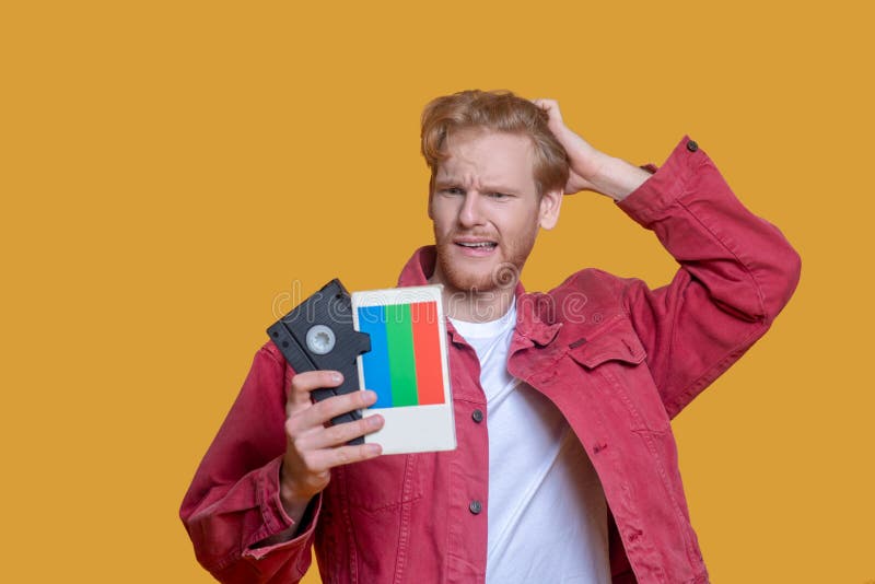 Ginger Young Man in Red Jacket with a Record Looking Puzzled Stock ...