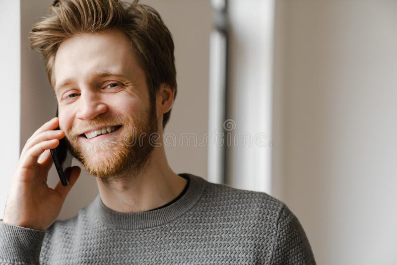 Ginger Young Man Talking on Mobile Phone while Standing Stock Image ...
