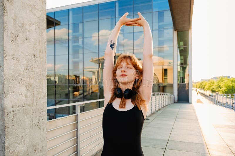 Ginger Young Woman with Headphones Doing Exercise during Workout Stock ...