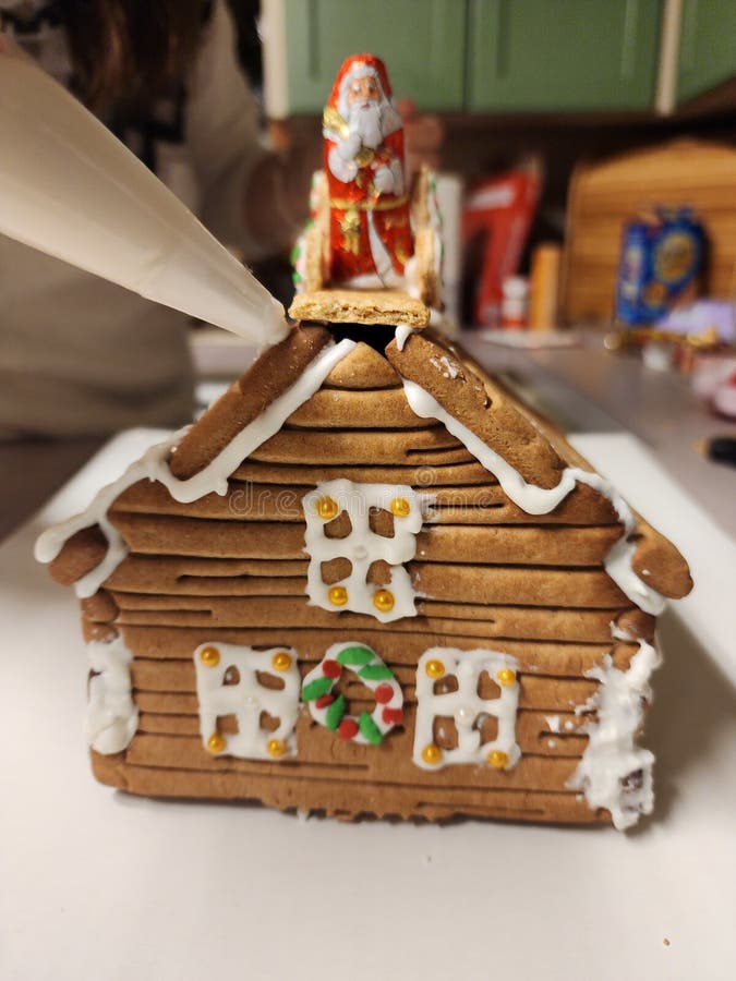 Gingerbread House with Santa on Top Stock Image - Image of buttercream ...