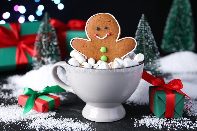 Gingerbread Man in Cup on Black Table Against Blurred Lights Stock ...