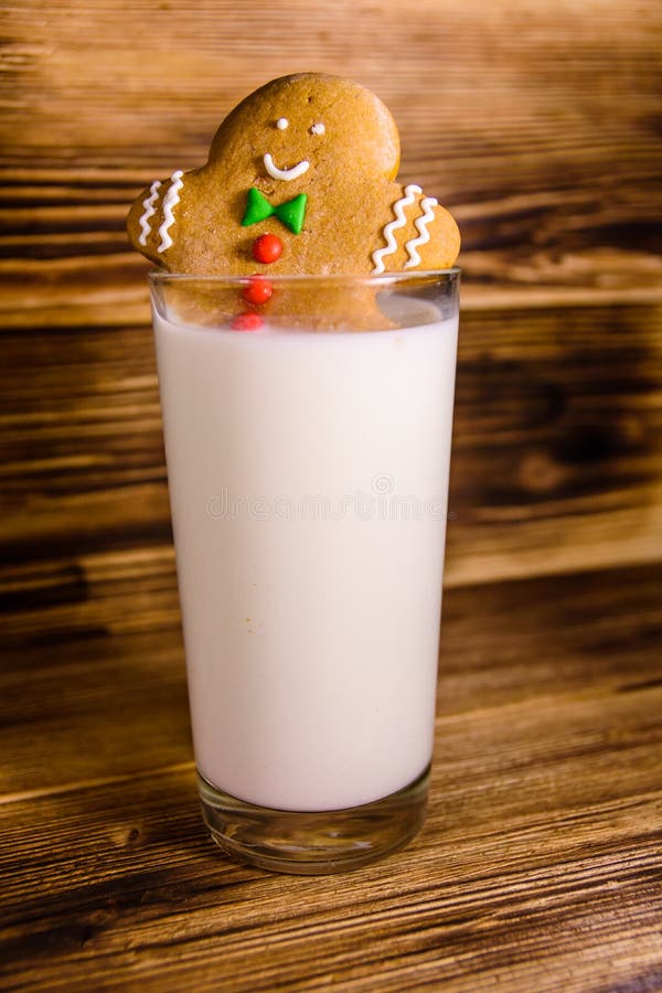 Gingerbread Man in a Glass of Milk on Wooden Table Stock Image - Image ...